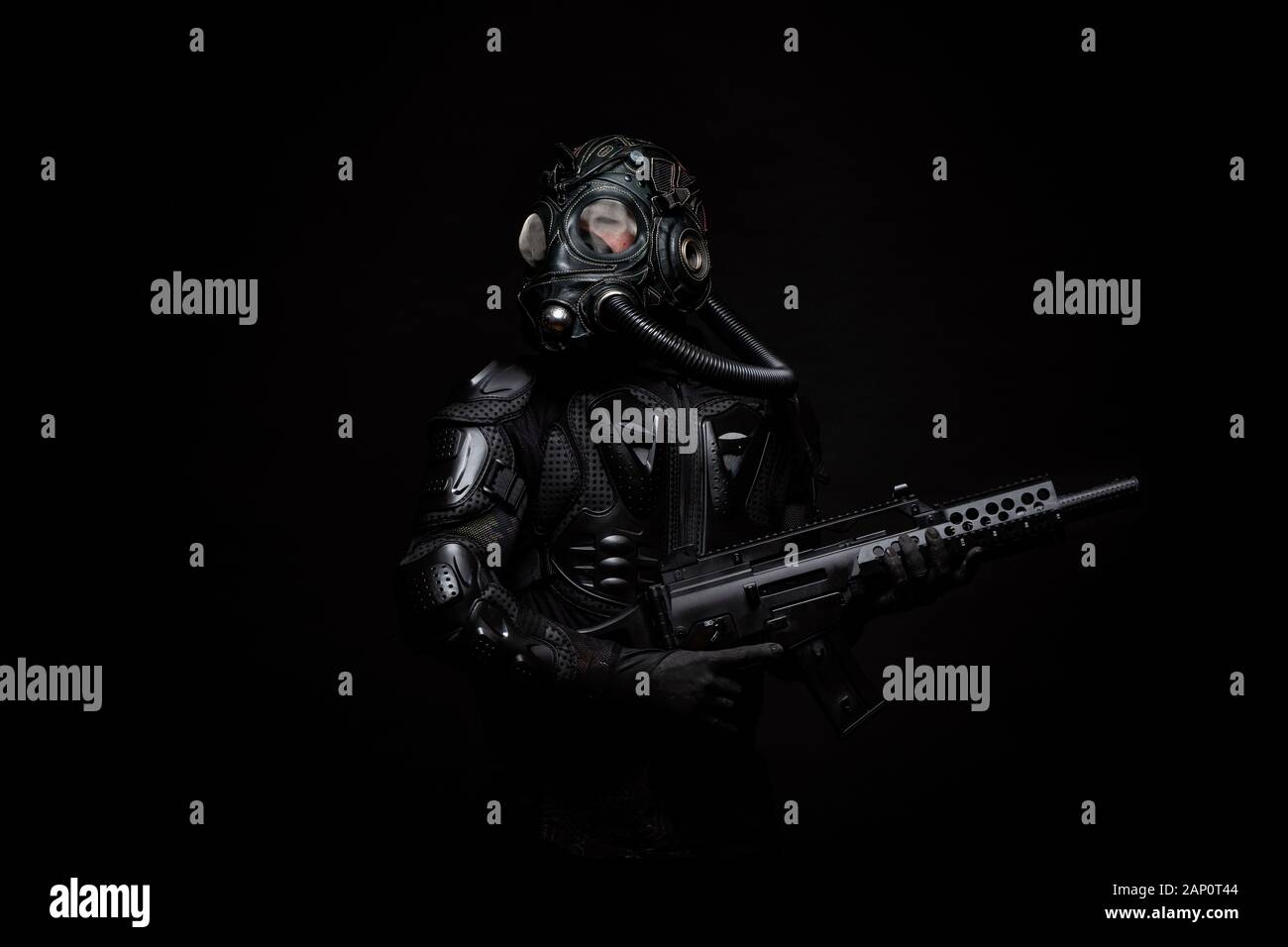 Futuristic warrior a machine gun in his hands Stock Photo - Alamy
