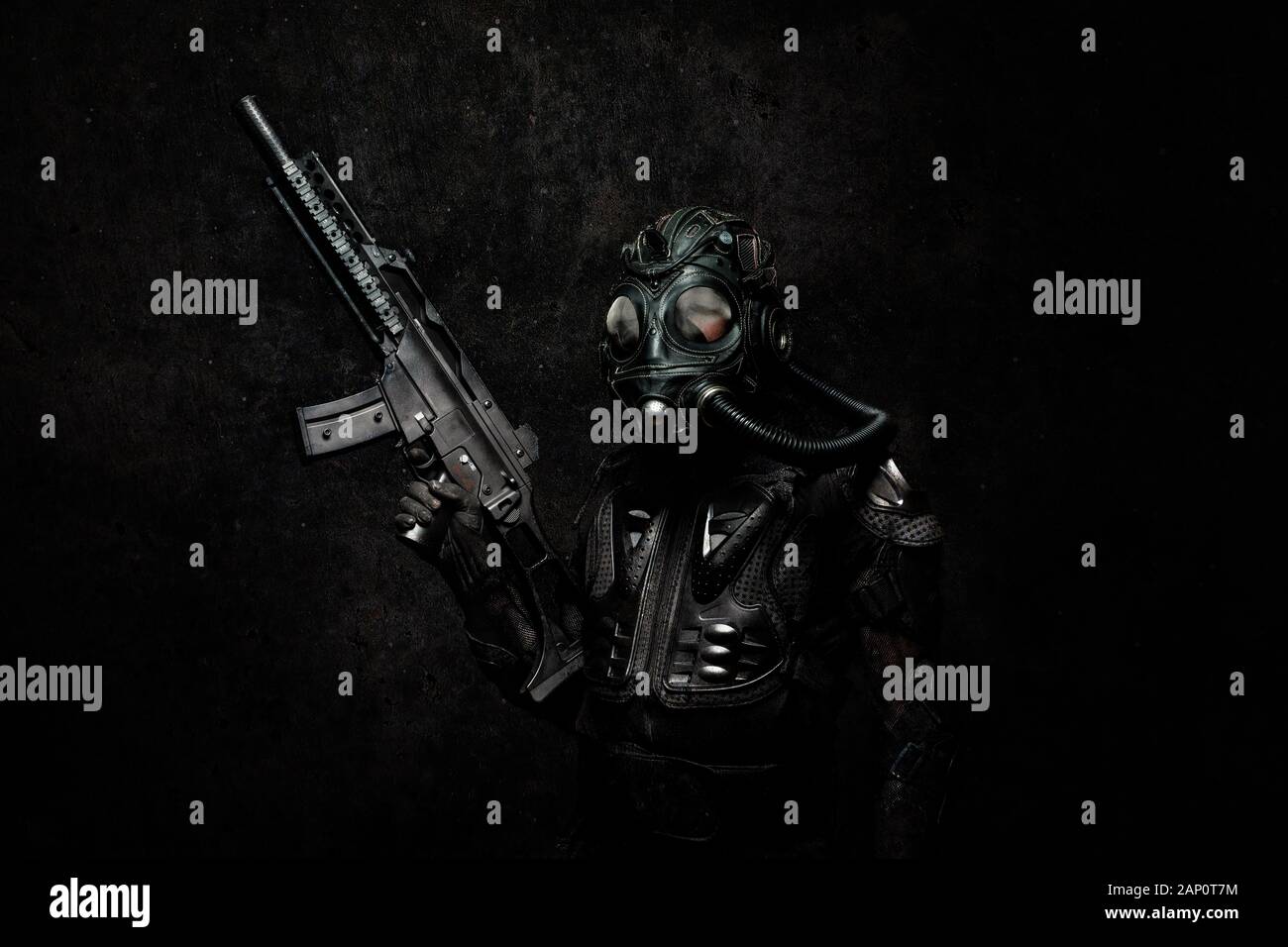 Futuristic warrior a machine gun in his hands Stock Photo - Alamy