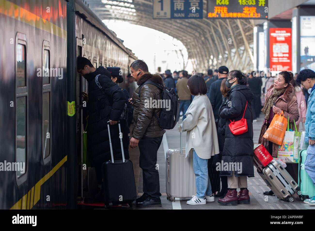 Chinese passengers queue up to board a train to go back home for the ...