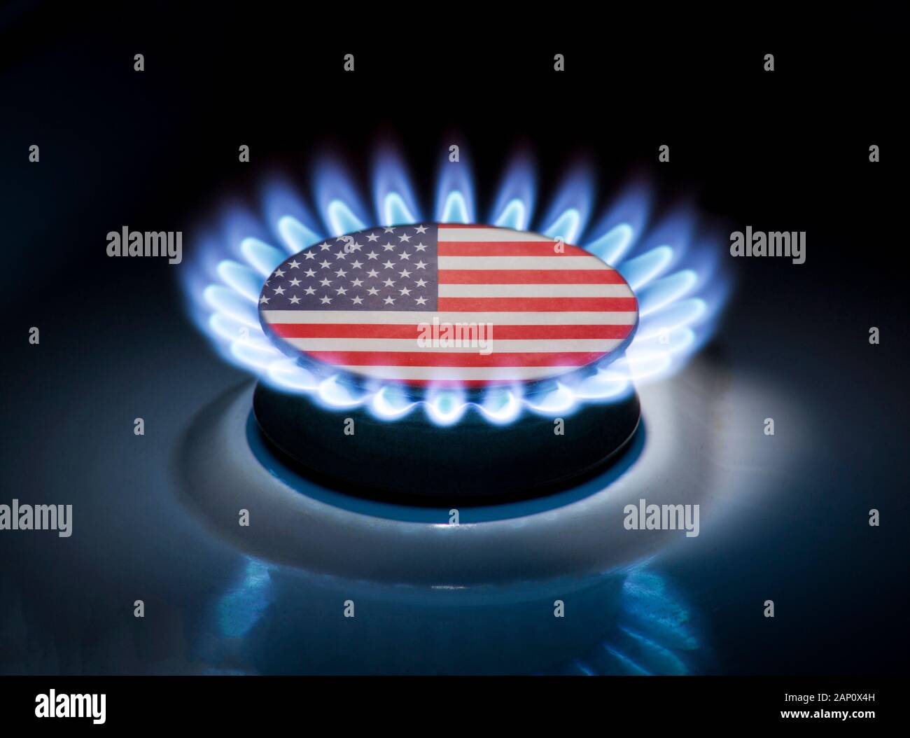 Burning gas burner of a home stove in the middle of which is the flag ...