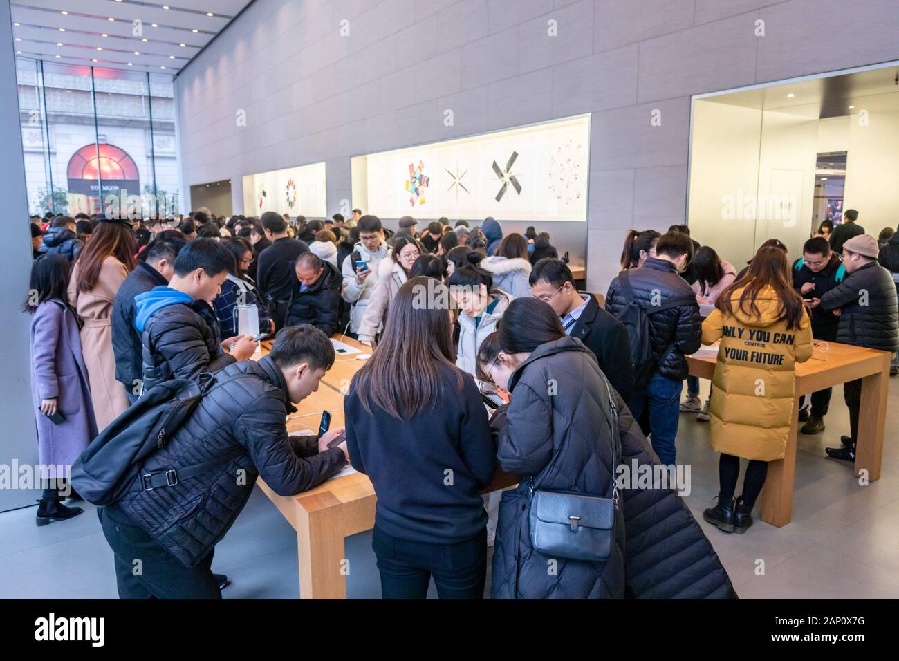 Customers crowd the Apple Store on the Nanjing Road shopping street in ...