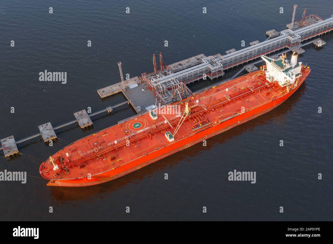 Oil tanker in industrial port at unloading of bulk contents, aerial ...