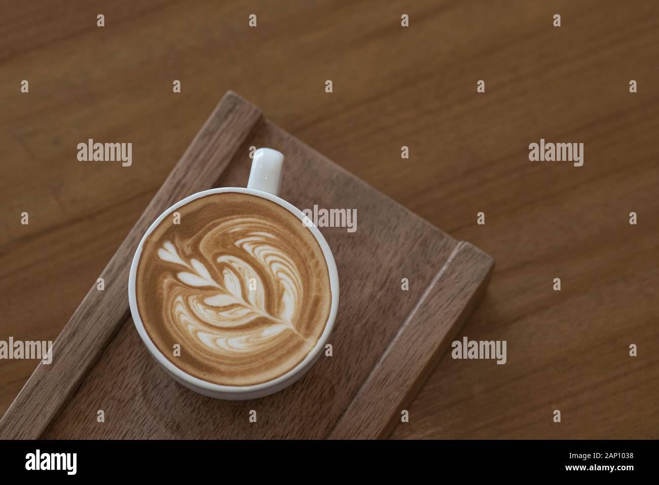 Hot nice Latte art foam coffee. Heart shape and tree leaf milk foam top up on hot latte coffee ...