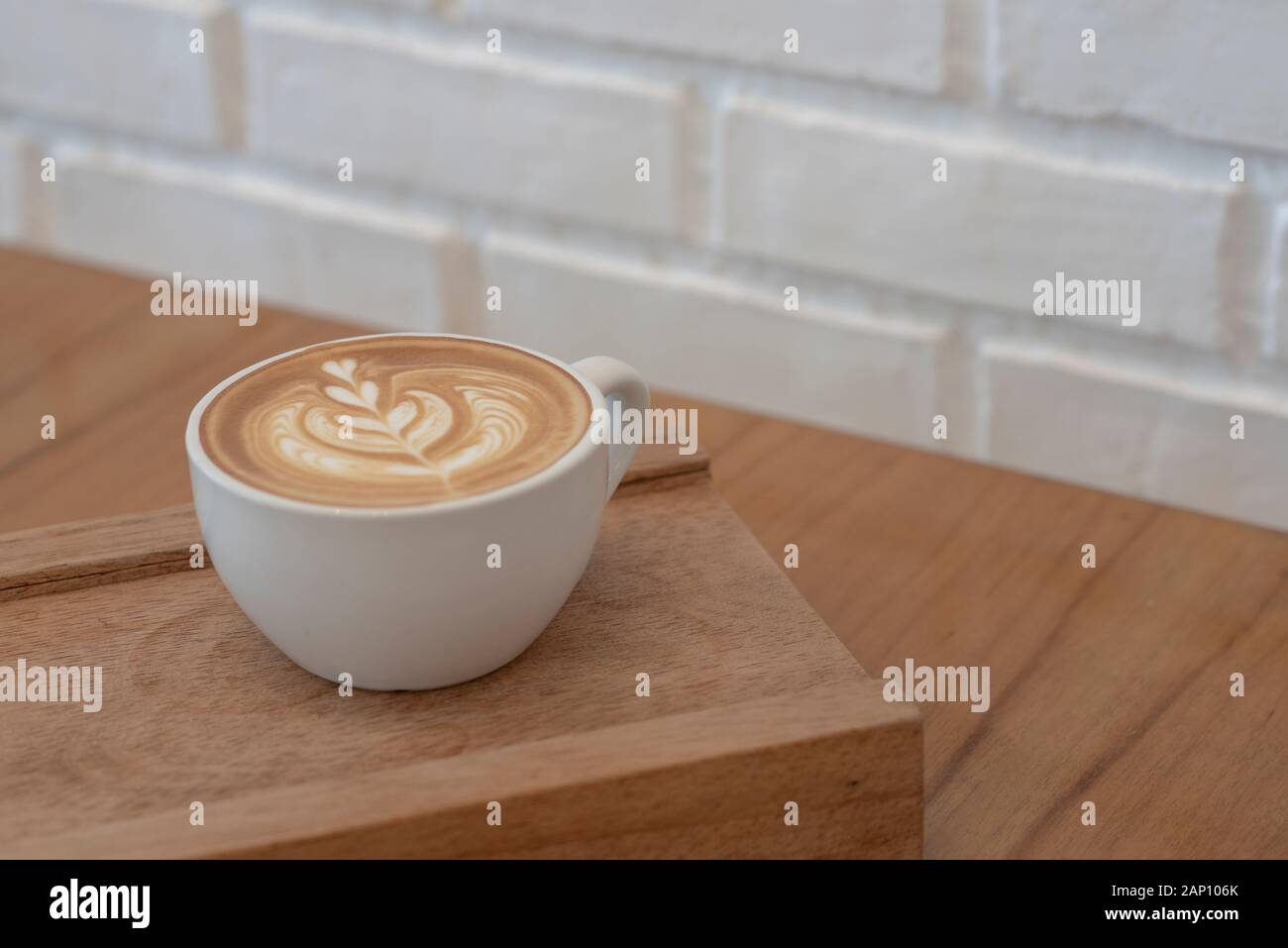 Hot nice Latte art foam coffee. Heart shape and tree leaf milk foam top up on hot latte coffee ...