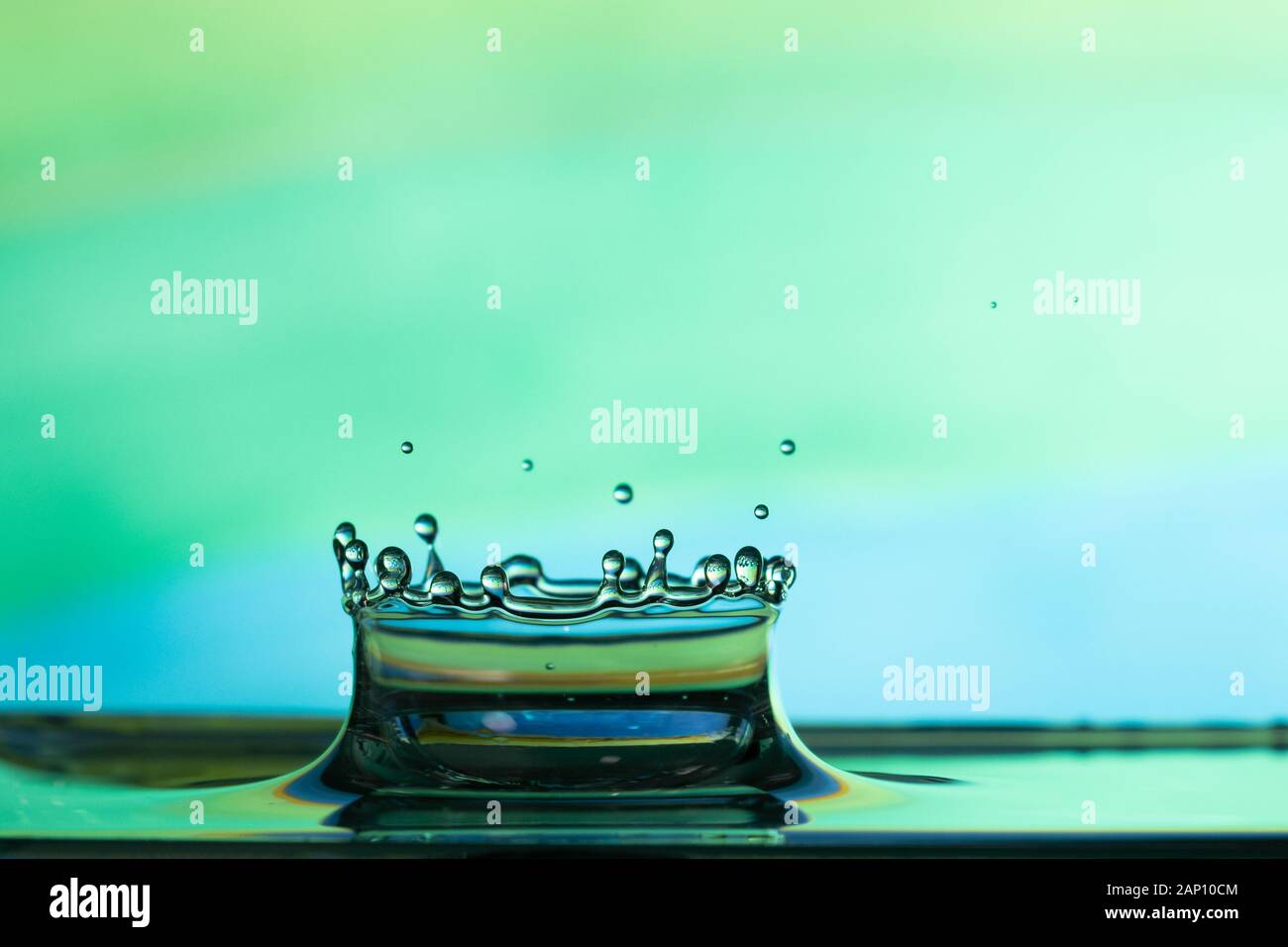 close up of a falling water drop impacting on a body of water on a ...