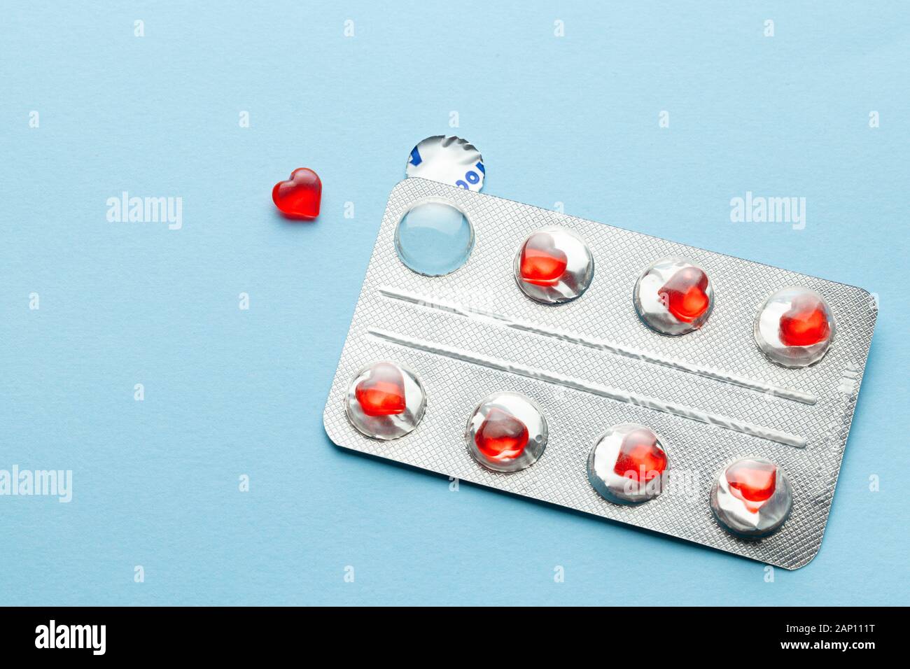 Love pills. Blister pack with red heart shaped pills. Tablets for ...
