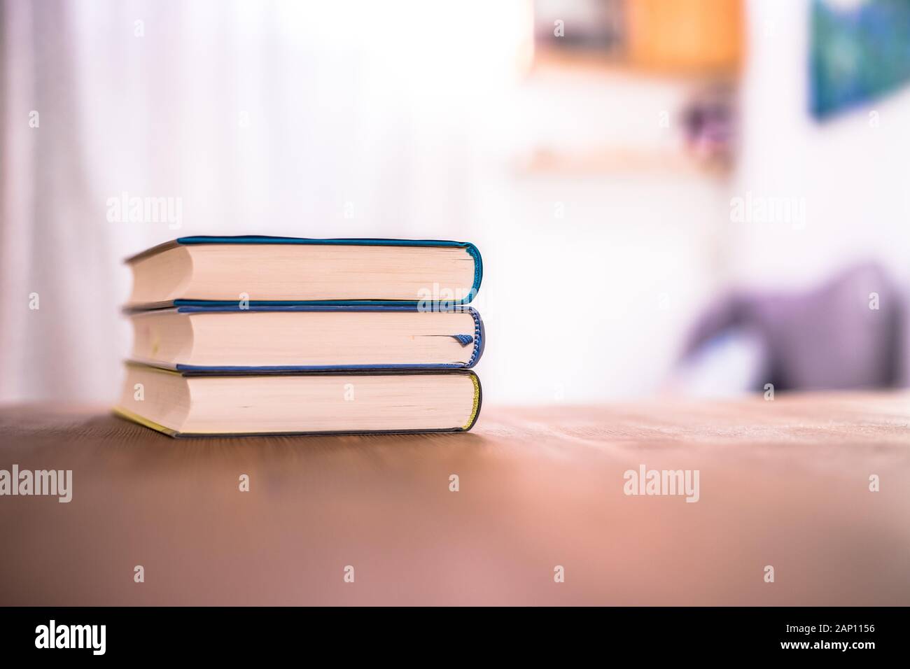 Stack of books lying on wooden desk at home. Knowledge and science ...