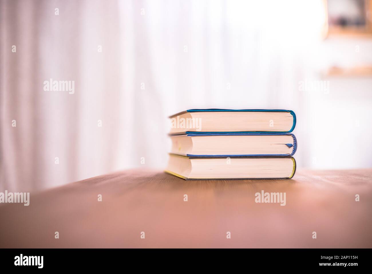 Stack of books lying on wooden desk at home. Knowledge and science ...