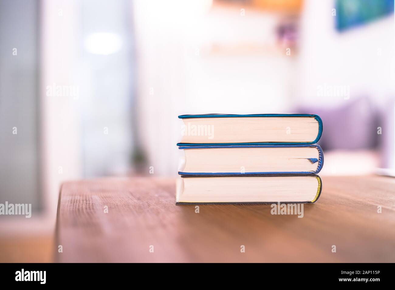 Stack of books lying on wooden desk at home. Knowledge and science ...