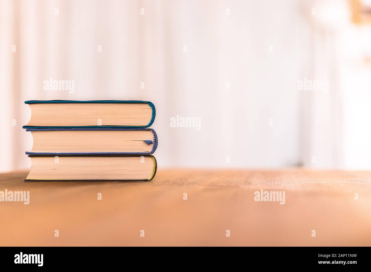 Stack of books lying on wooden desk at home. Knowledge and science ...