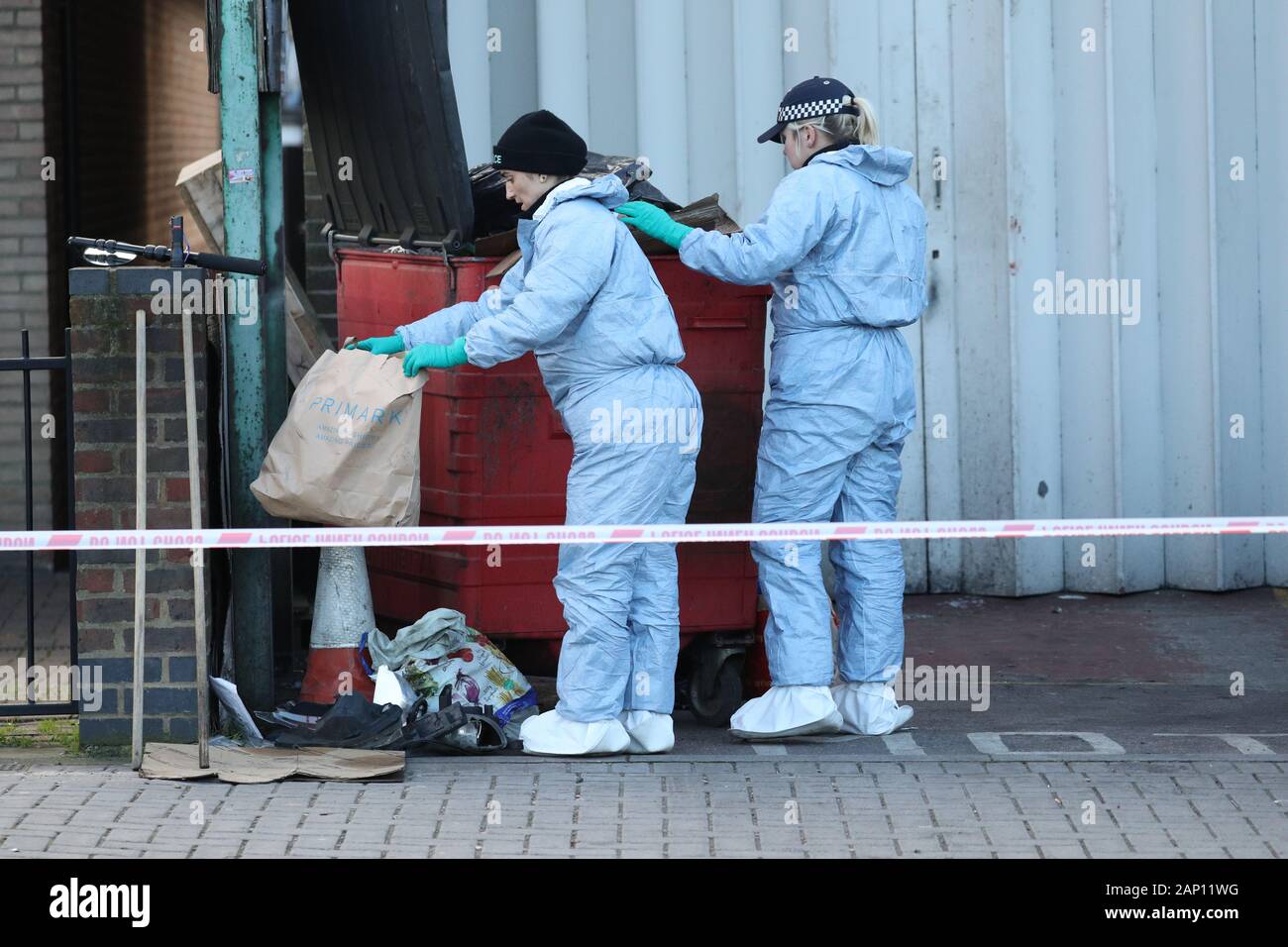 Scenes of crime officers (SOCO) search through a bin outside Motor ...