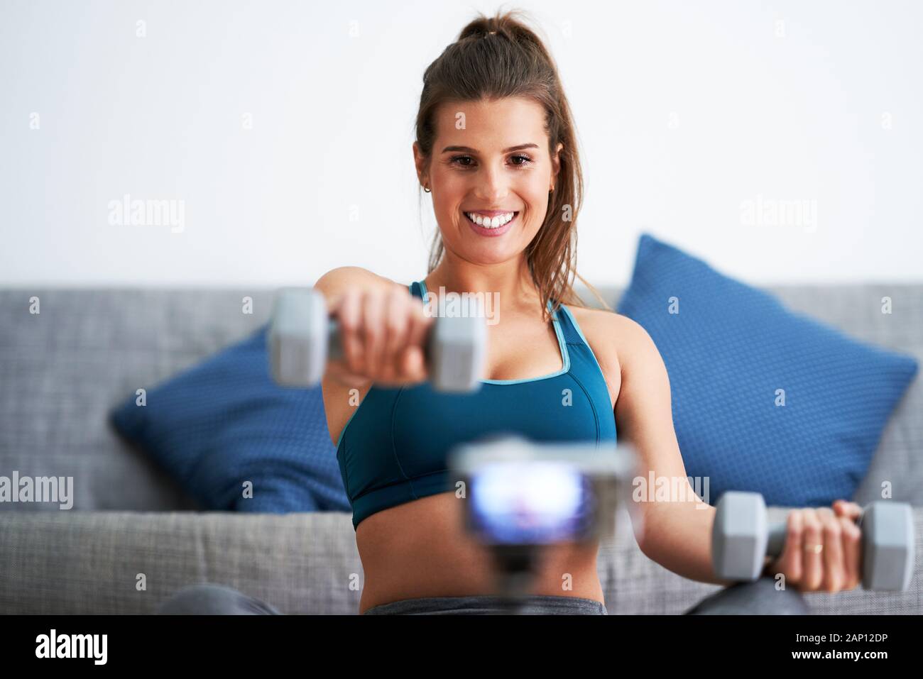 Fitness vlogger influencer recording live tutorial video Stock Photo ...