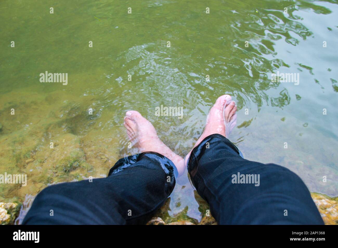 The foot of the two feet that lie in the flowing waterfall Until the ...