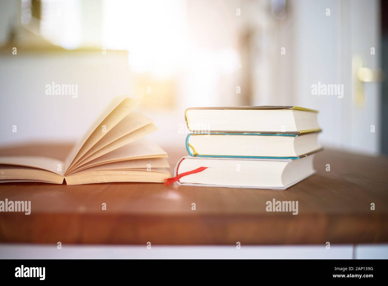 Stack of books lying on wooden desk at home. Knowledge and science ...