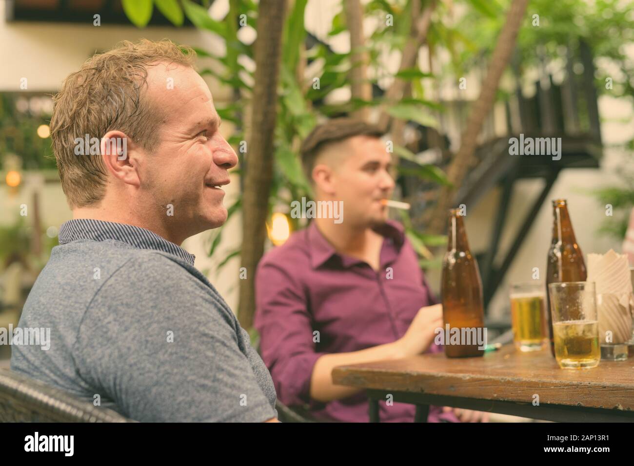 Portrait of men as group of friends hanging out and relaxing together ...