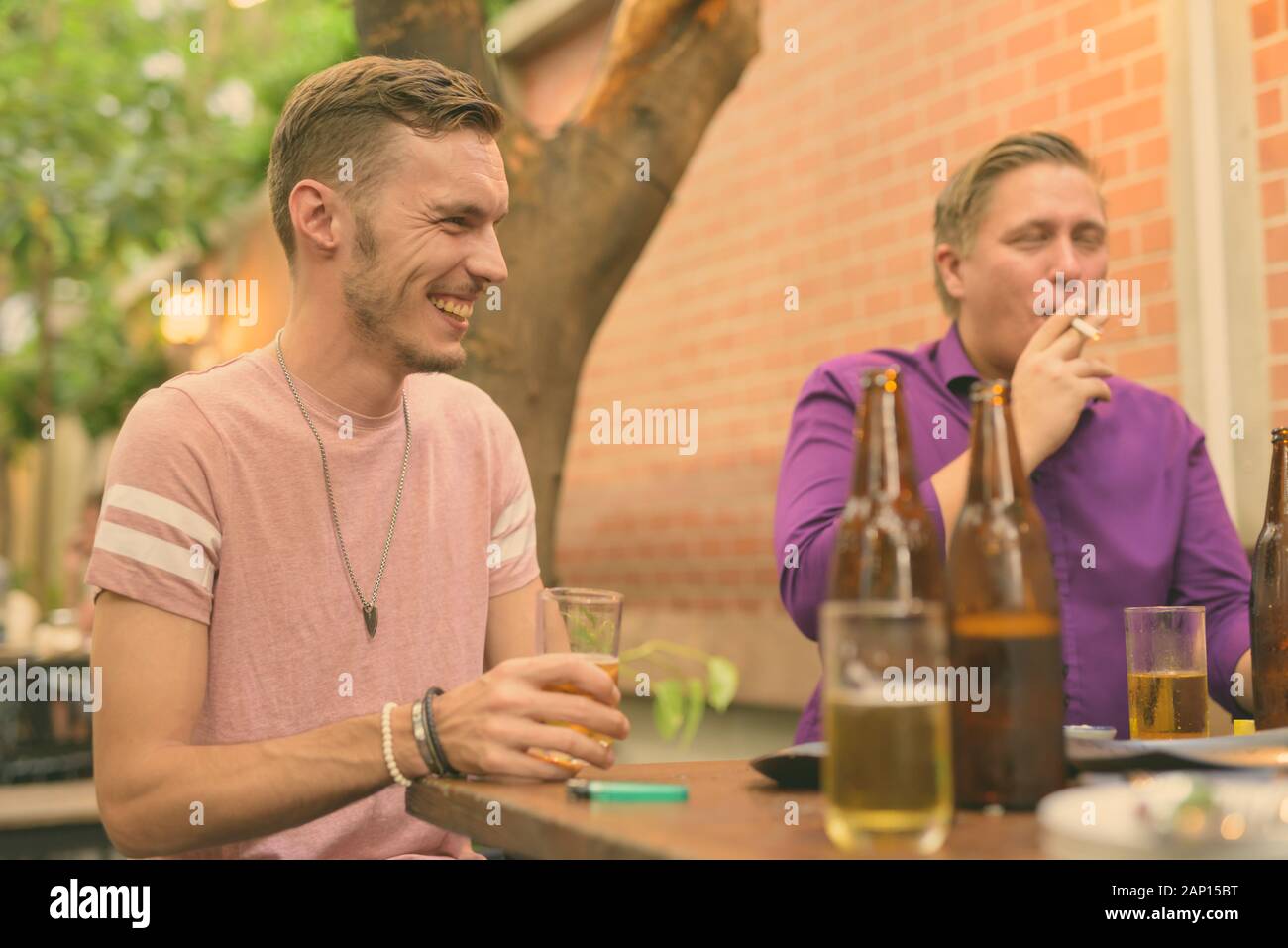 Portrait of men as group of friends hanging out and relaxing together ...