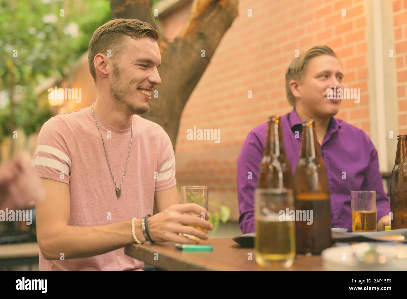 Portrait of men as group of friends hanging out and relaxing together ...