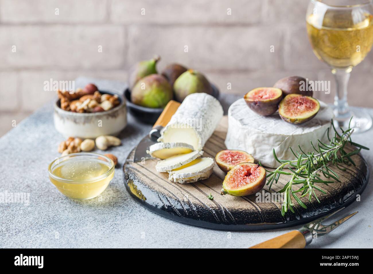 Fresh goat brie cheese with truffle and white mold on cheese platter ...