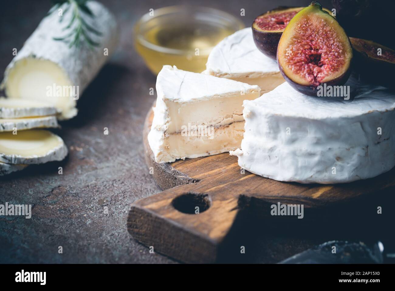 Fresh goat brie cheese with truffle and white mold on cheese platter ...