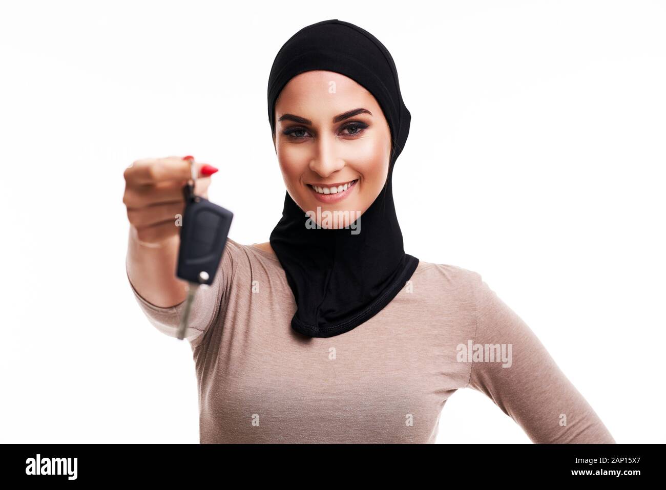 Muslim woman with car keys over white background Stock Photo - Alamy