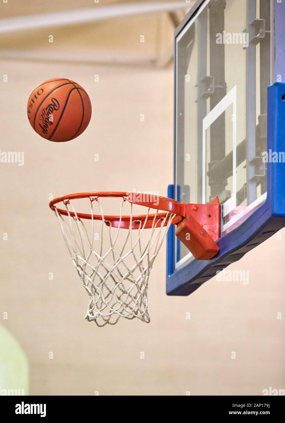 Basketball falling into basketball hoop during youth basketball game ...