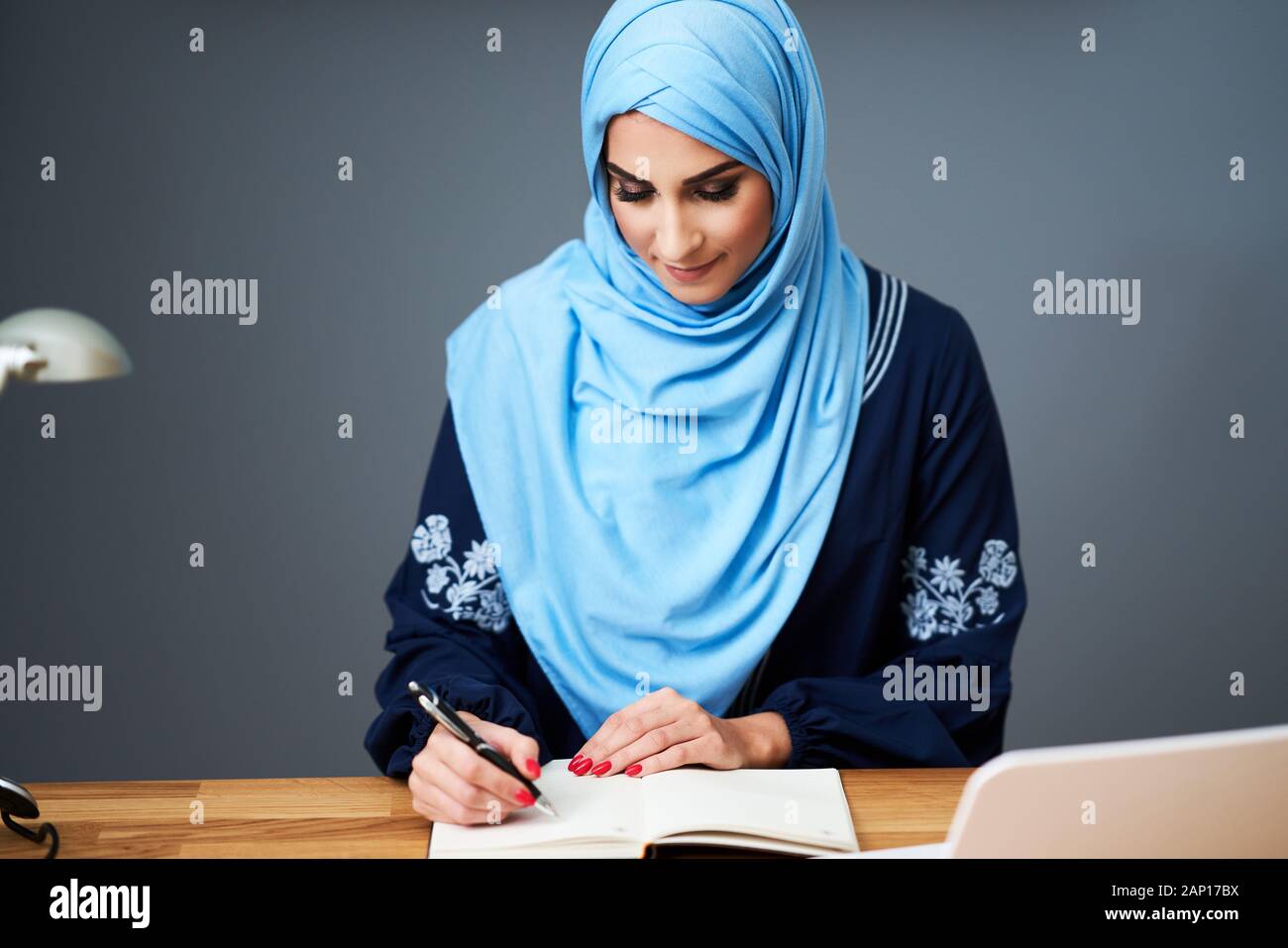 Muslim female student learning at home Stock Photo - Alamy
