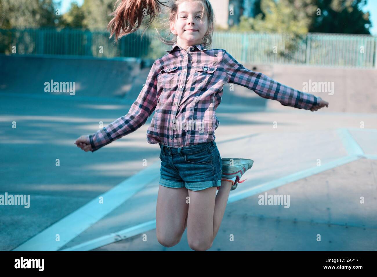 Portrait of a little girl jumping rope Stock Photo - Alamy