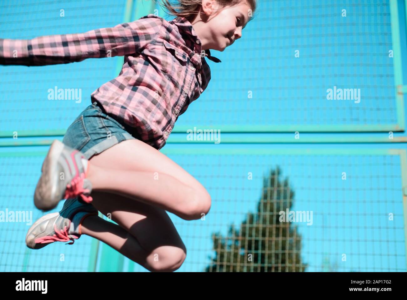 Portrait of a little girl jumping rope Stock Photo - Alamy