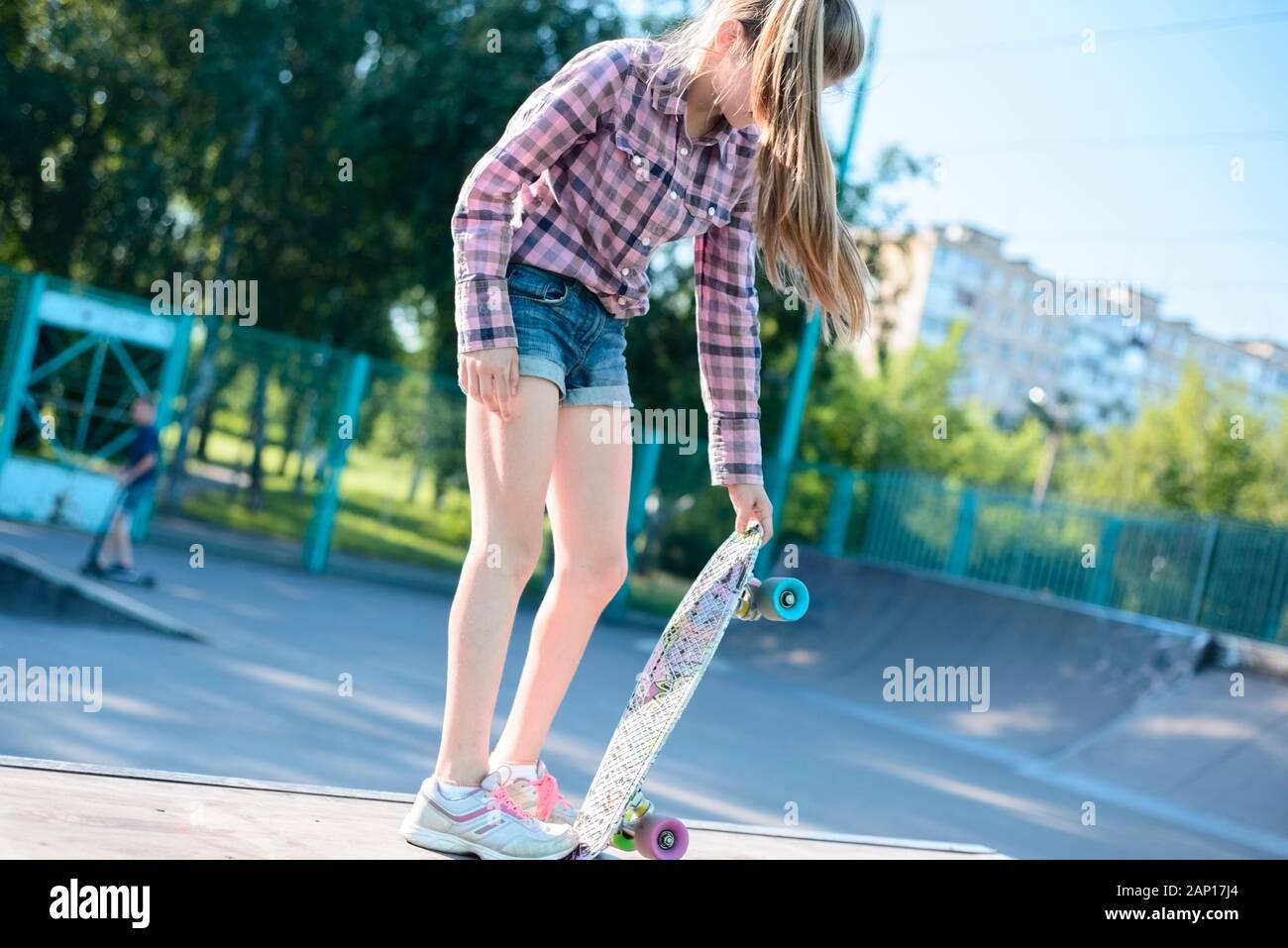 Skater female rides on skateboard at skate park ramp. Young woman ...