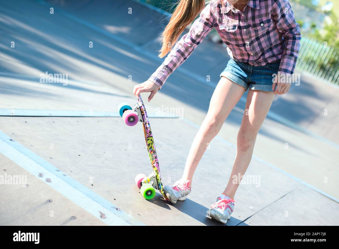 Skater female rides on skateboard at skate park ramp. Young woman ...