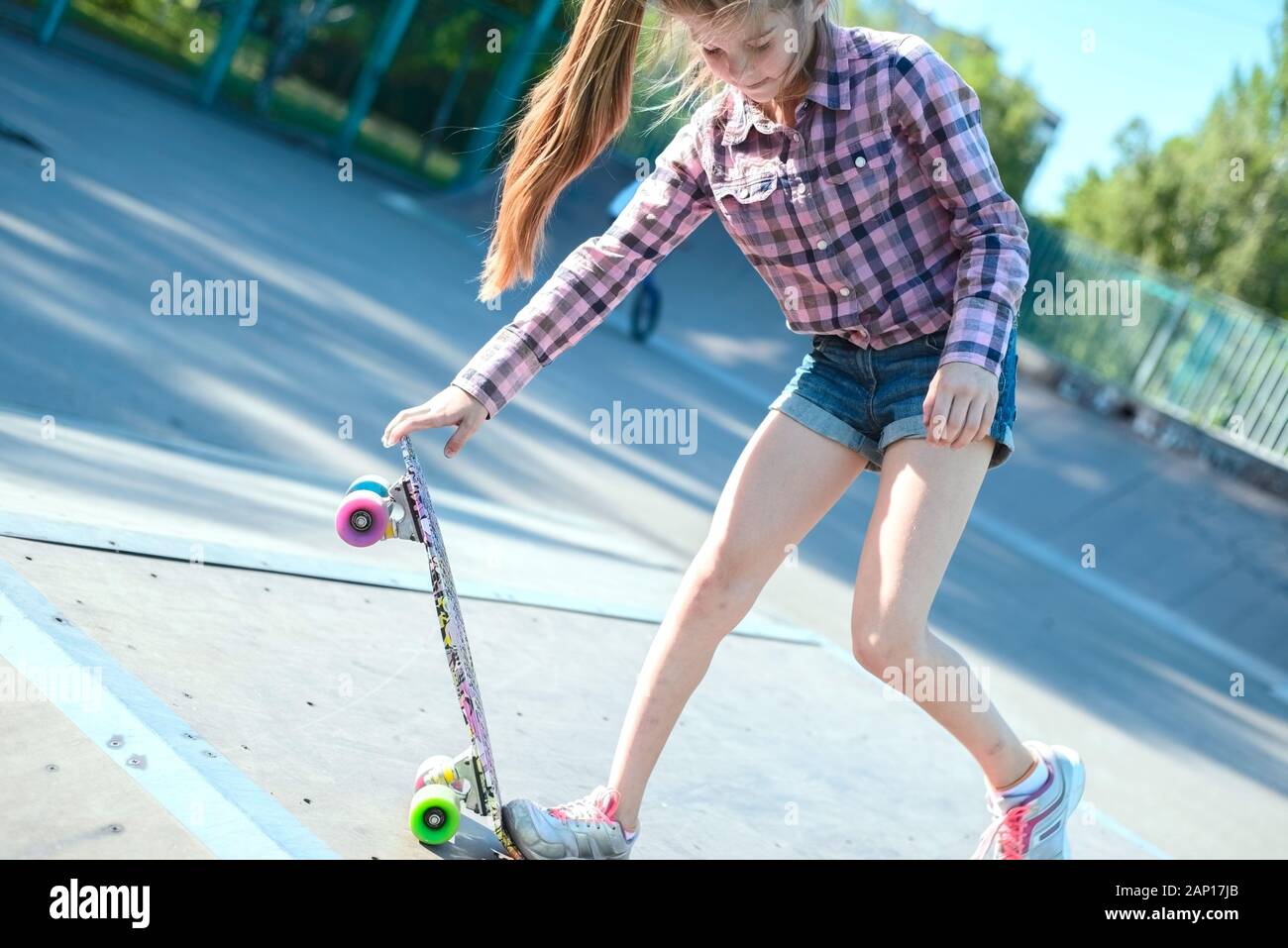 Skater female rides on skateboard at skate park ramp. Young woman ...