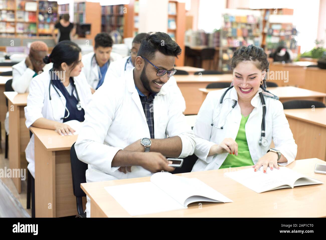 smart medical students, mixed race. Sitting at the table, exams at the ...