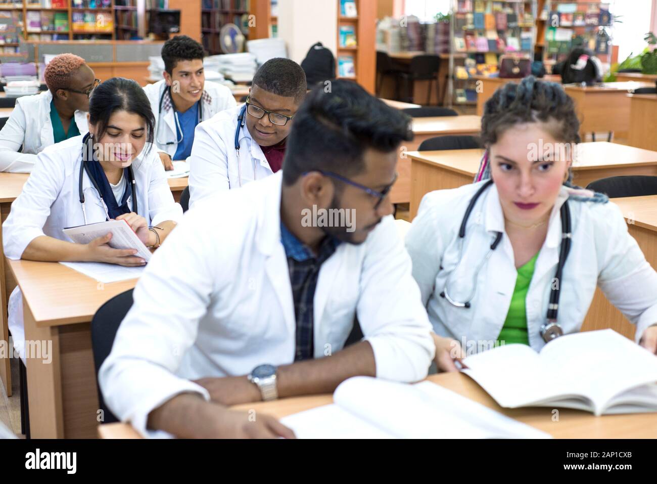 smart medical students, mixed race. Sitting at the table, exams at the ...