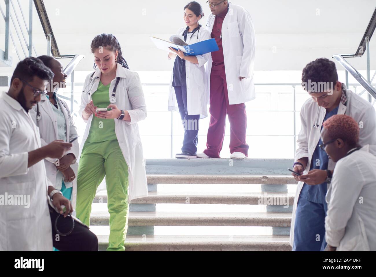 young doctors, mixed race, sitting, standing on the steps, in the ...