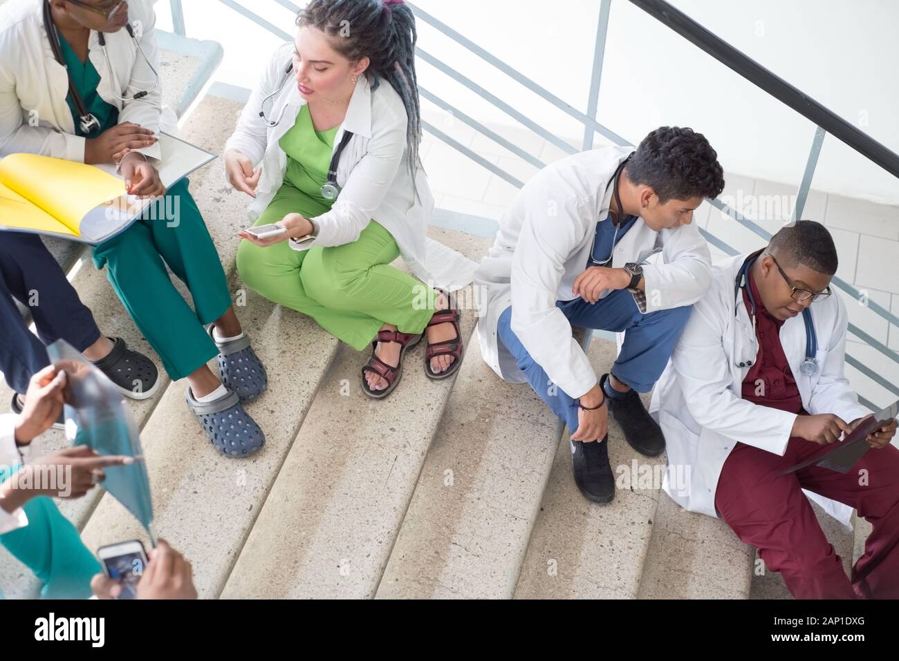 young doctors, mixed race, sitting, standing on the steps, in the ...