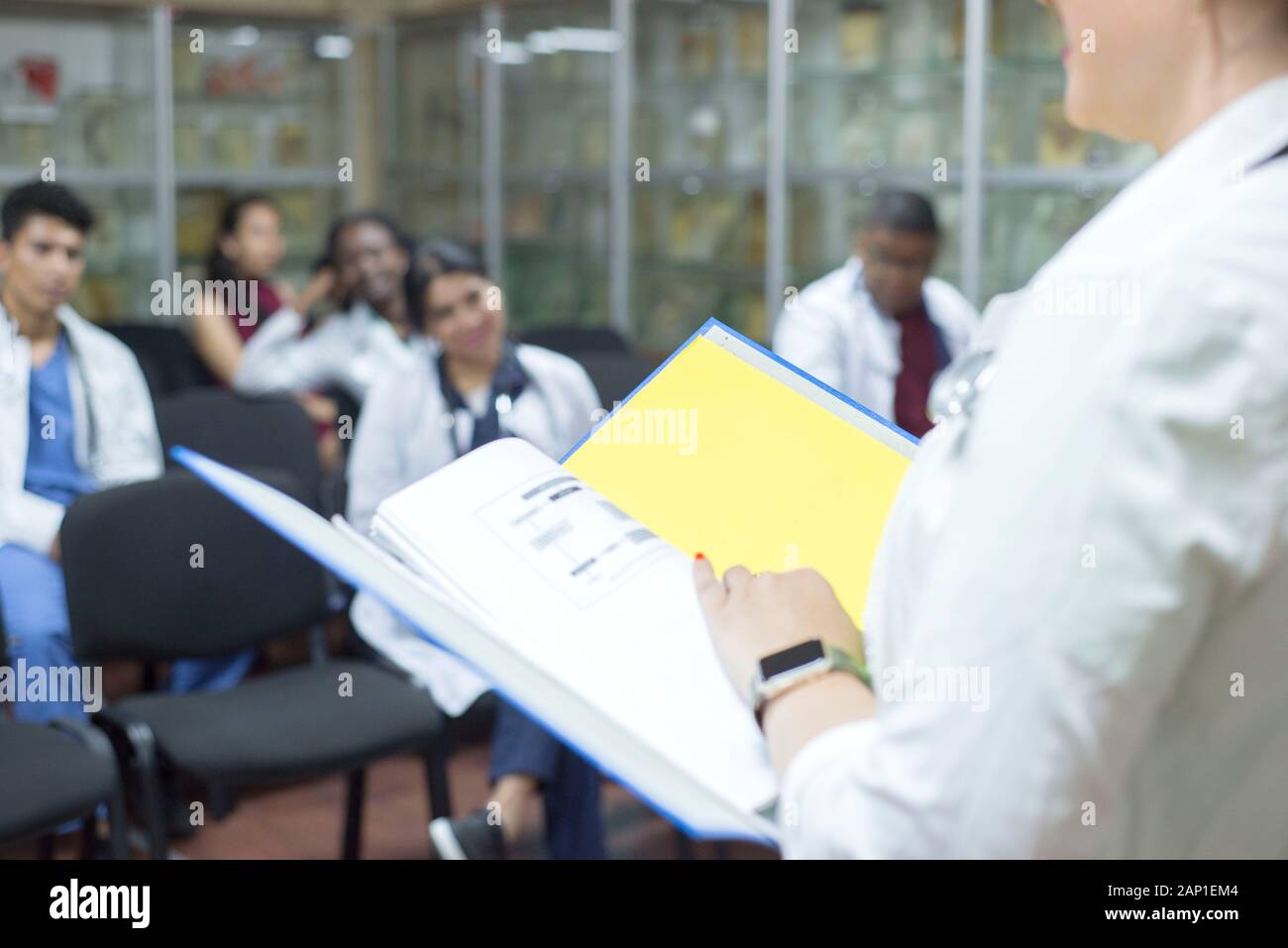 doctors, mixed race, in the classroom, at a medical conference. Young ...