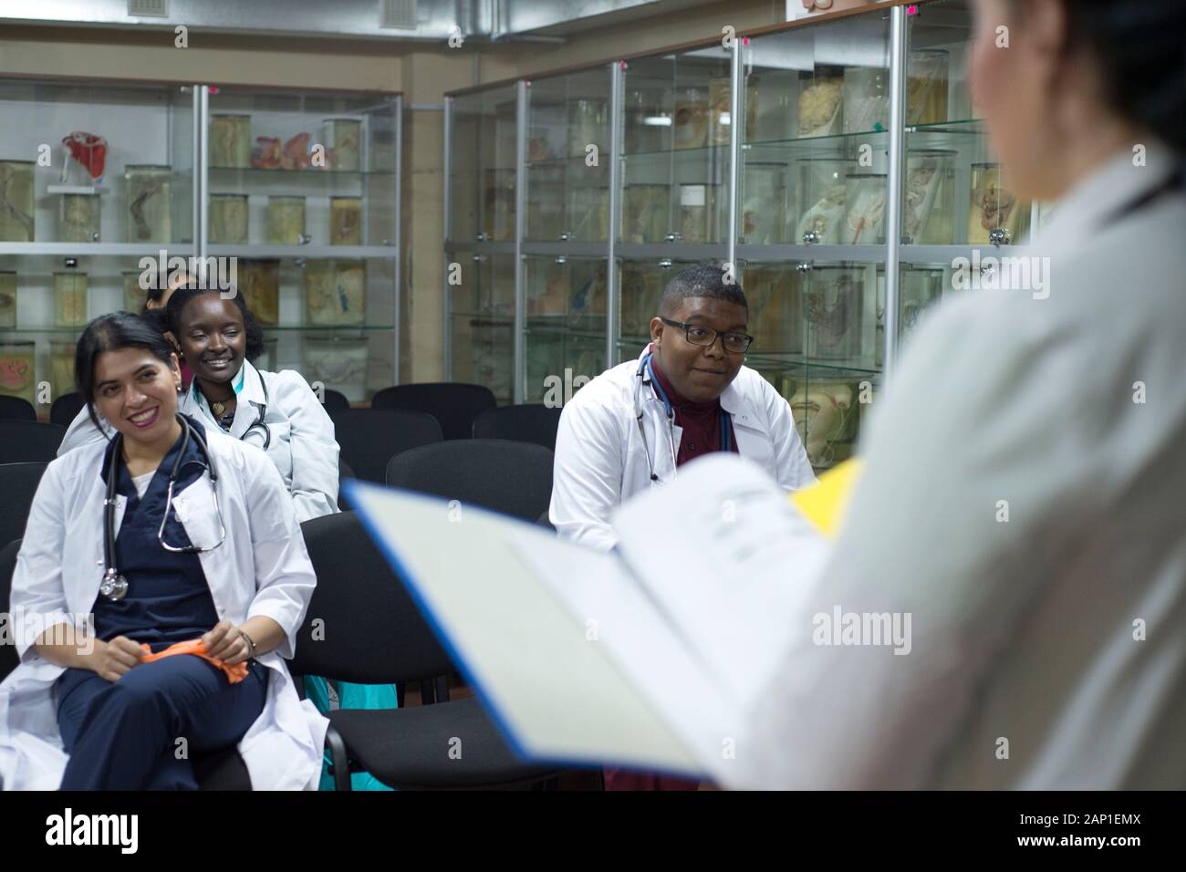 doctors, mixed race, in the classroom, at a medical conference. Young ...