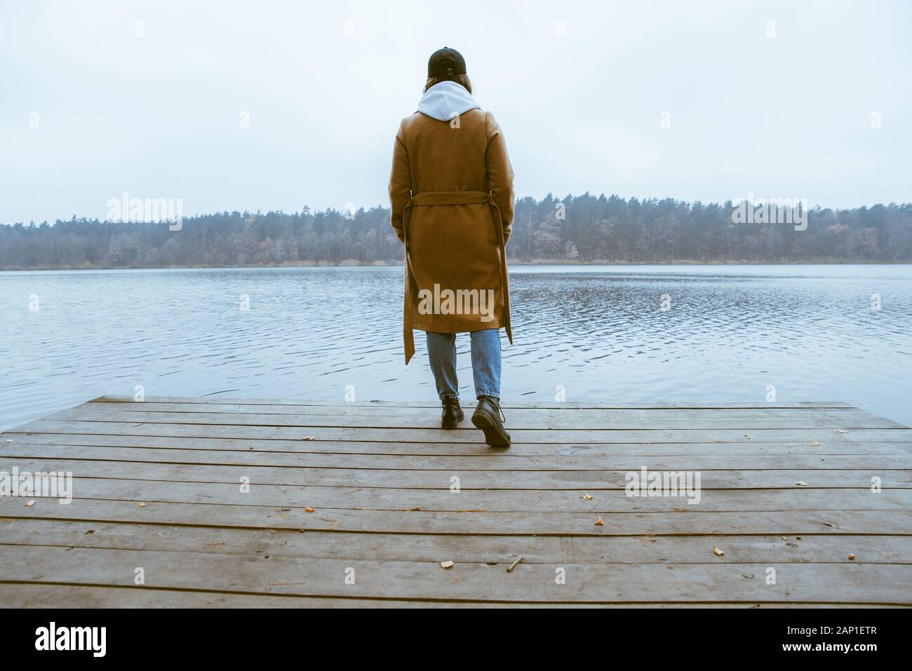 autumn lake season woman in coat at wooden pier Stock Photo - Alamy