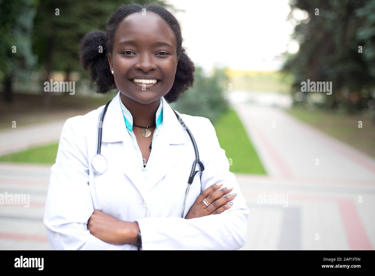portrait of a young beautiful african girl, doctor. Woman in white coat ...