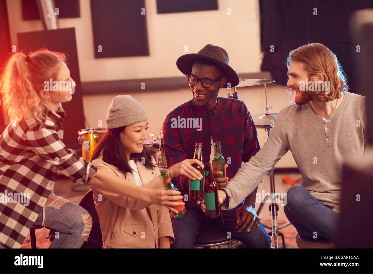 Multi-ethnic group of young people drinking beer while enjoying ...