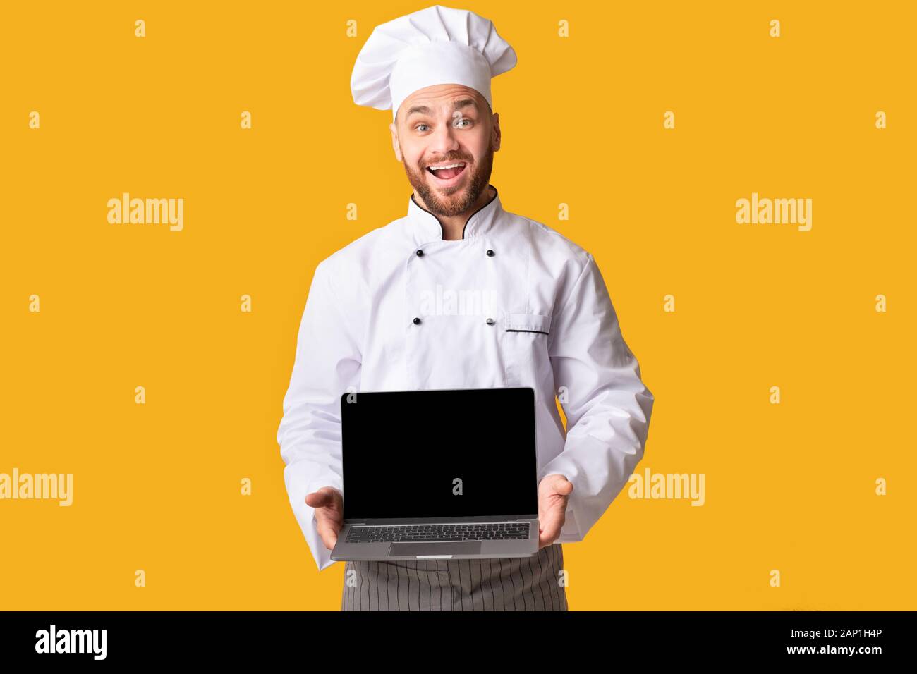 Chef Holding Laptop Computer Showing Blank Screen On Yellow Background ...