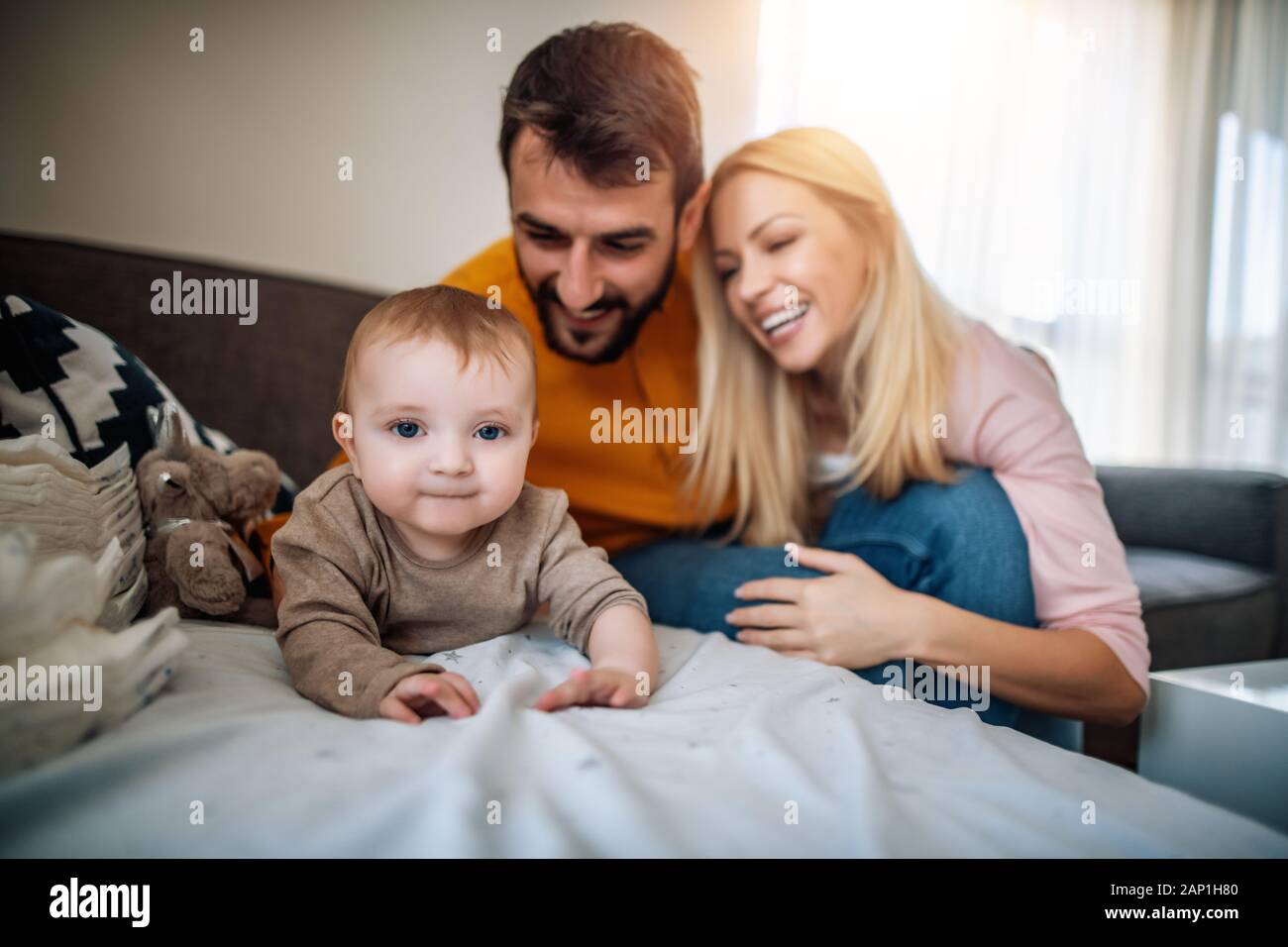 Happy parents changing diaper to their baby boy Stock Photo - Alamy