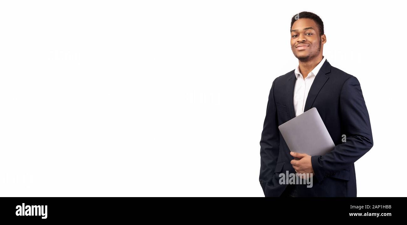 Confident afro man holding laptop on white background Stock Photo - Alamy