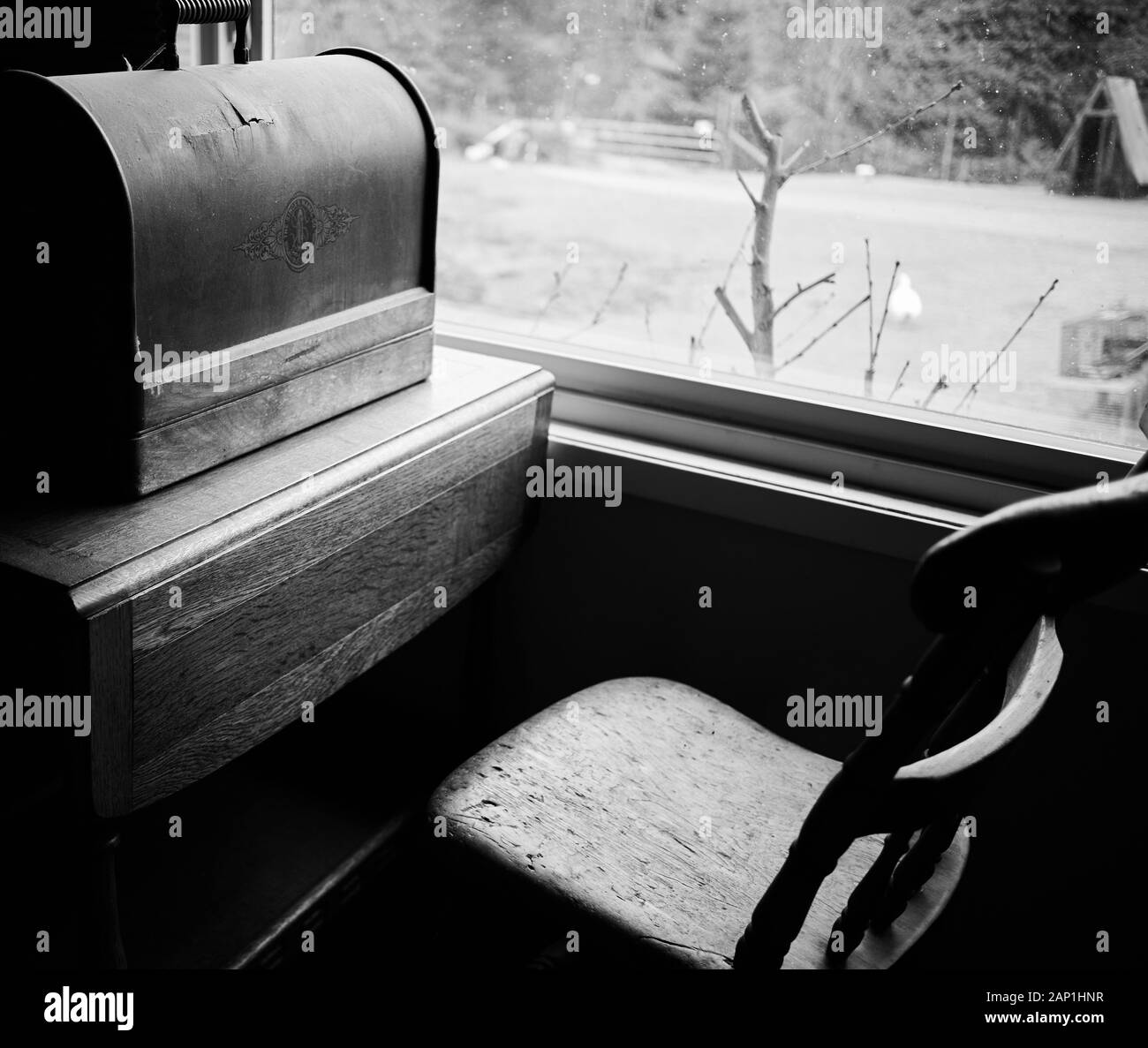 antique dusty bentwood box sewing machine case and old chair next to a ...