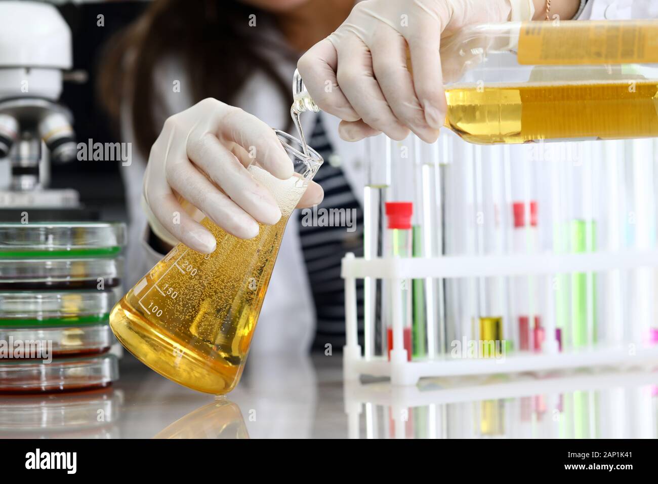 Scientist making mixture of fluid for experiment Stock Photo - Alamy