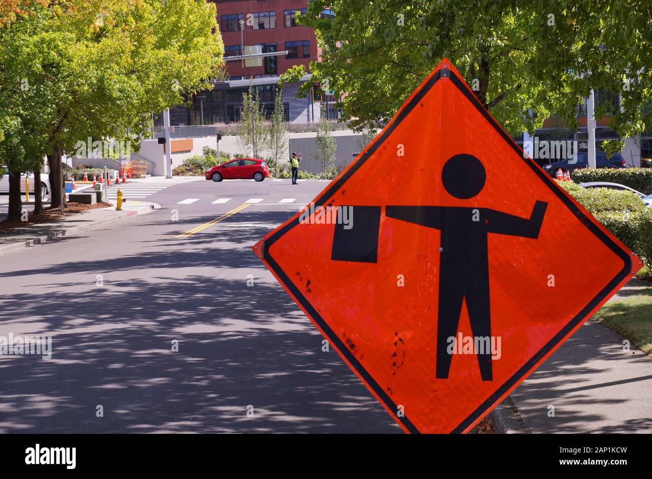 In the background a policeman directing the movement of cars. Sign ...