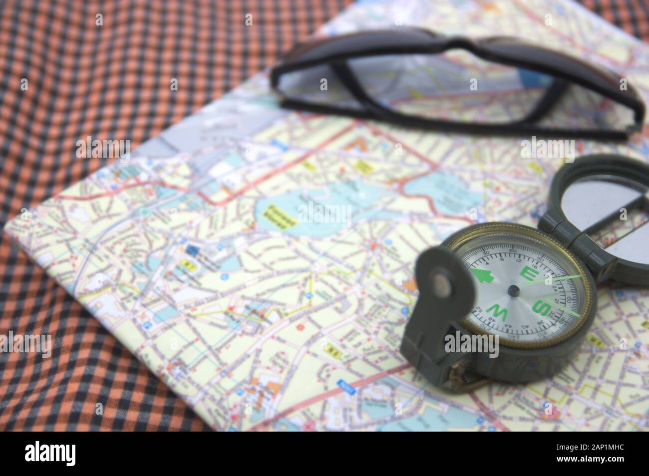 On a table we see a compass and a paper map to find the destination ...