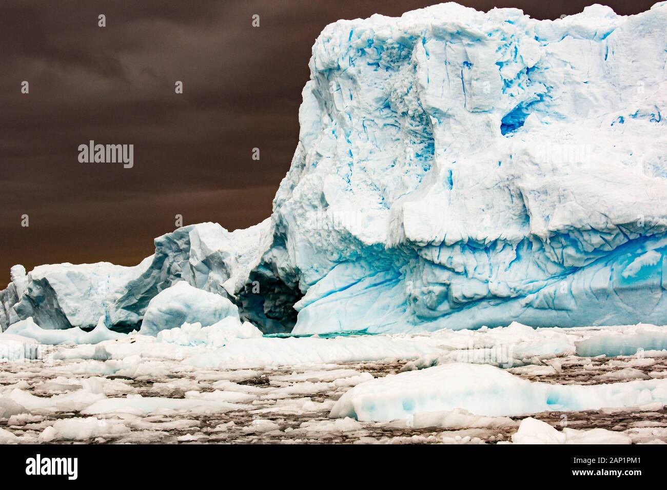 Blue ice of a glacier in Antarctica. The ice of blue icebergs contains ...