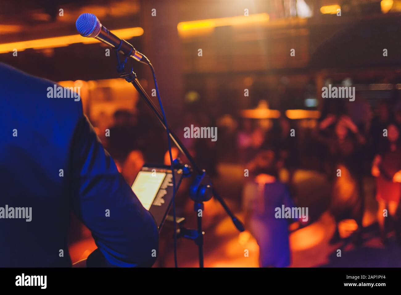 Singer performs on the stage illuminated by lights Stock Photo - Alamy