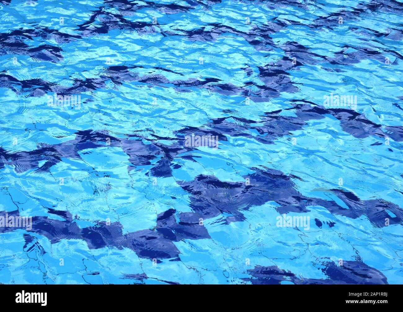 The water surface of the swimming pool turquoise color, illuminated by ...